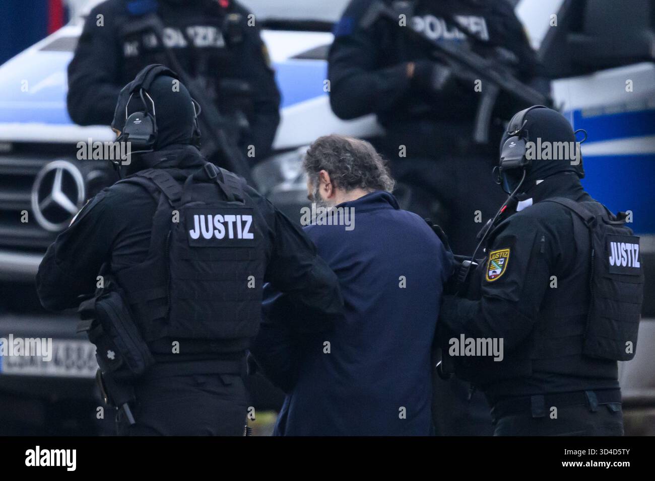 Taleb al-Abdulmohsen, center, is led to the motorcade by judicial staff ...