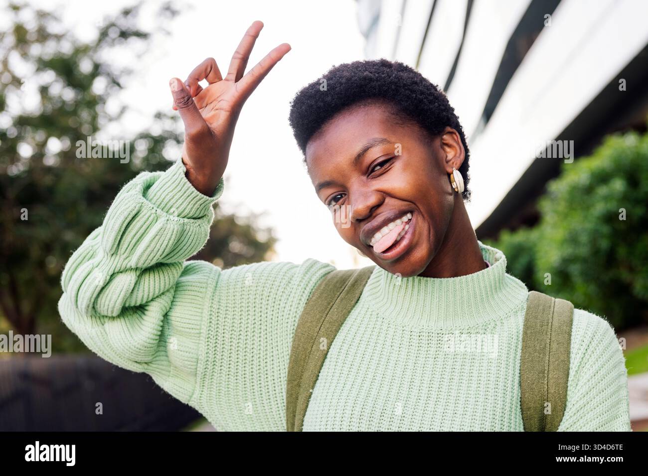 Woman making peace sign hi-res stock photography and images - Alamy