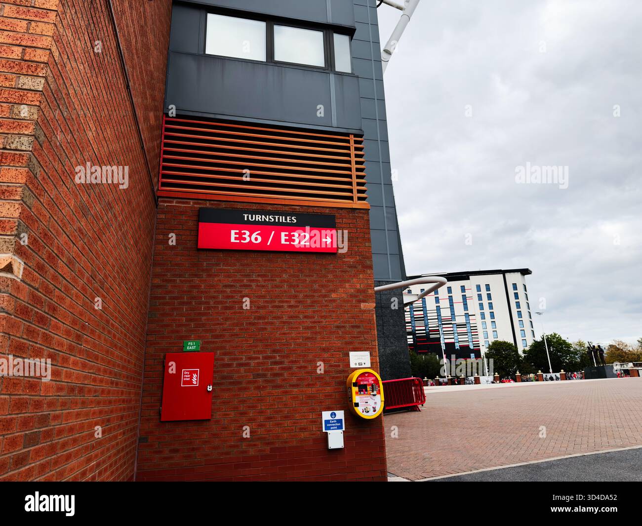 Manchester, UK - September 30, 2025: Red sign and turnstiles beside a ...