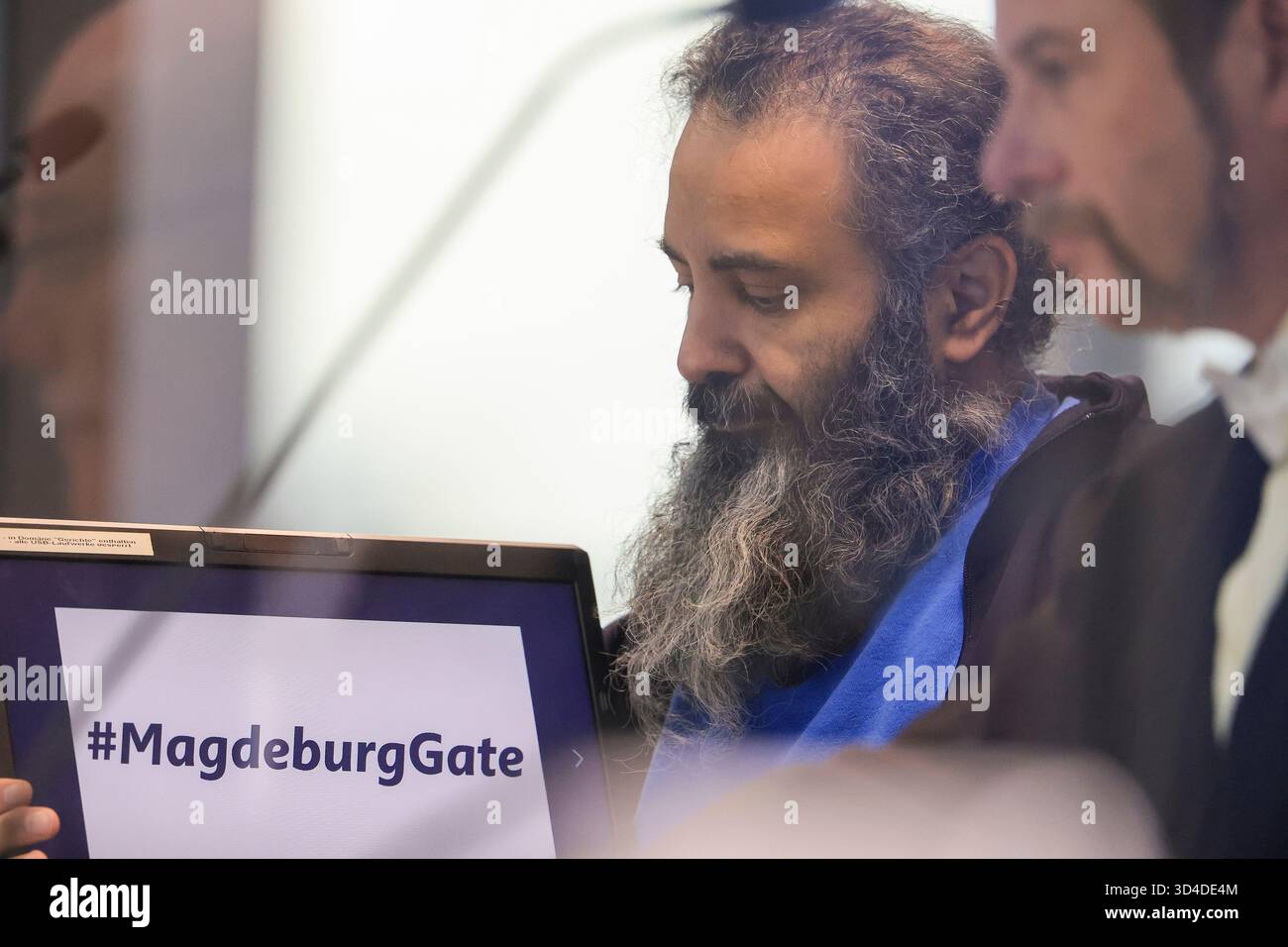 Defendant Taleb al-Abdulmohsen sits in a bullet-proof glass box in the ...