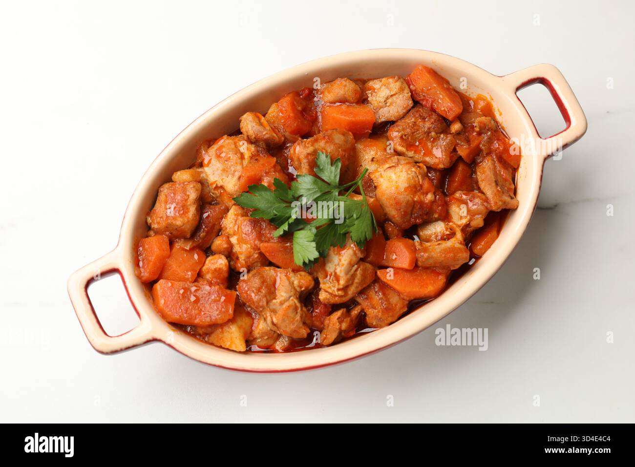 Delicious cooked stew in baking dish on white marble table, top view ...