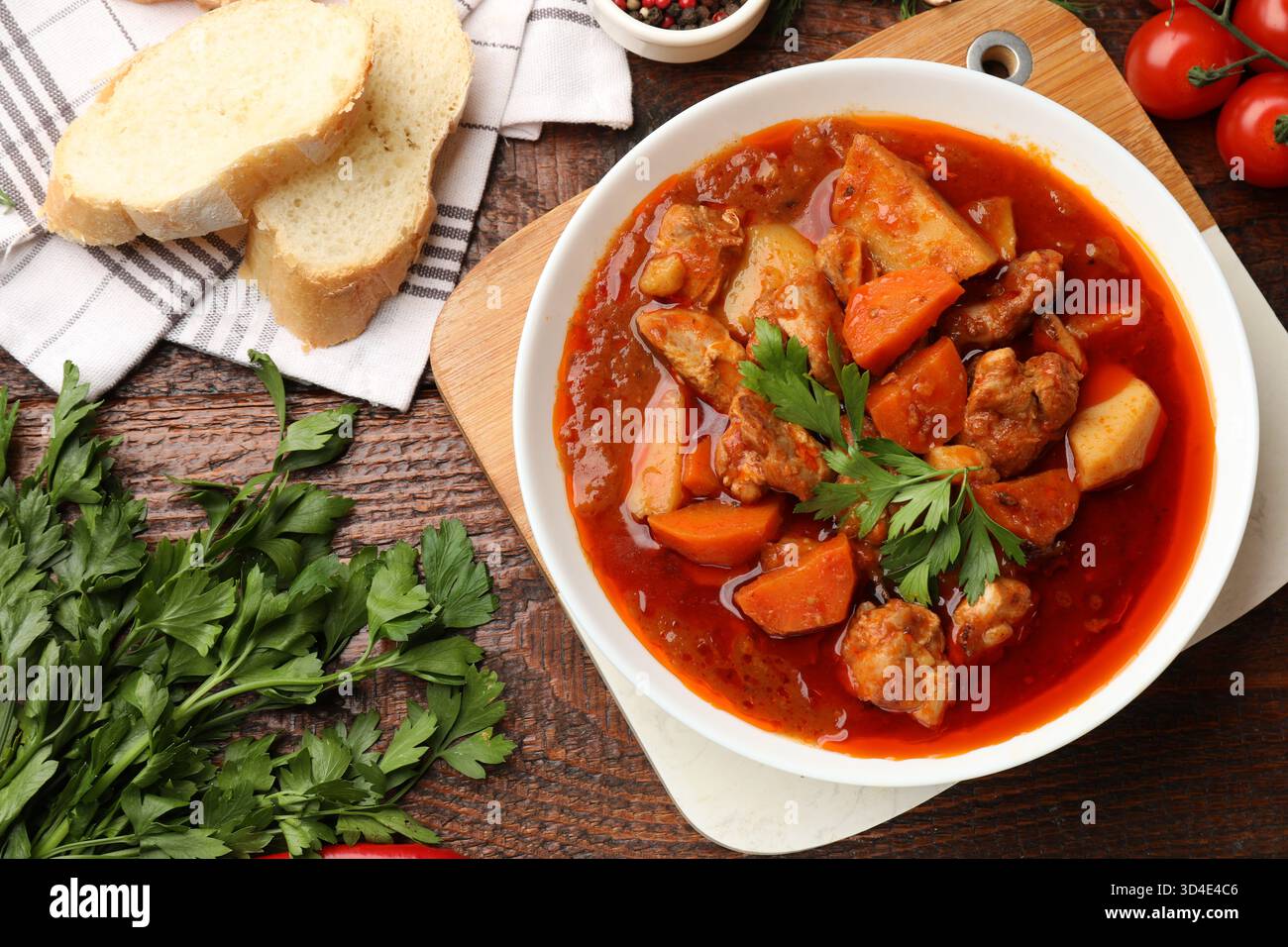 Delicious cooked stew served on wooden table, flat lay Stock Photo - Alamy