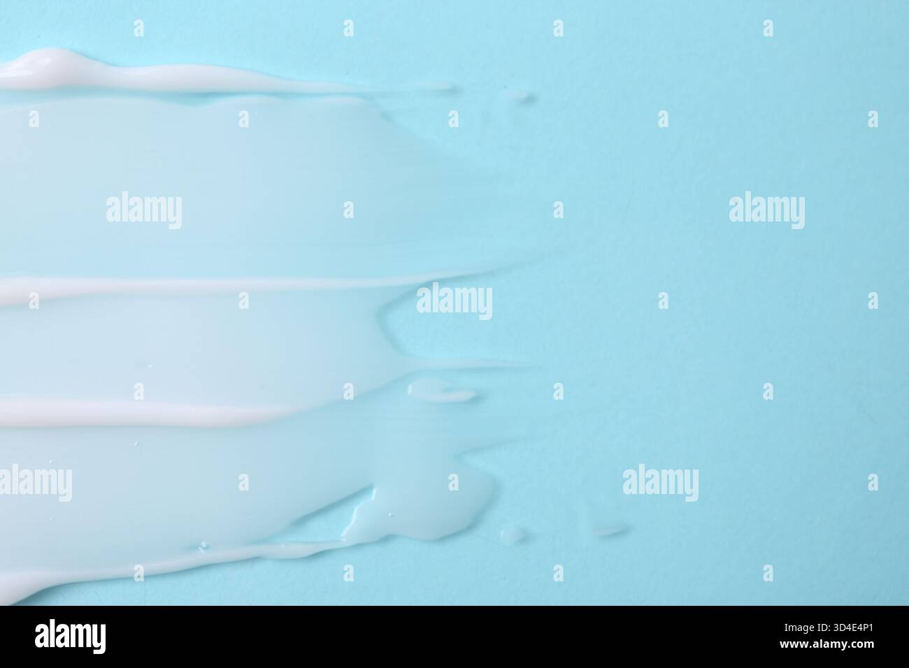 Sample of moisturizing cream on light blue background, top view. Space ...