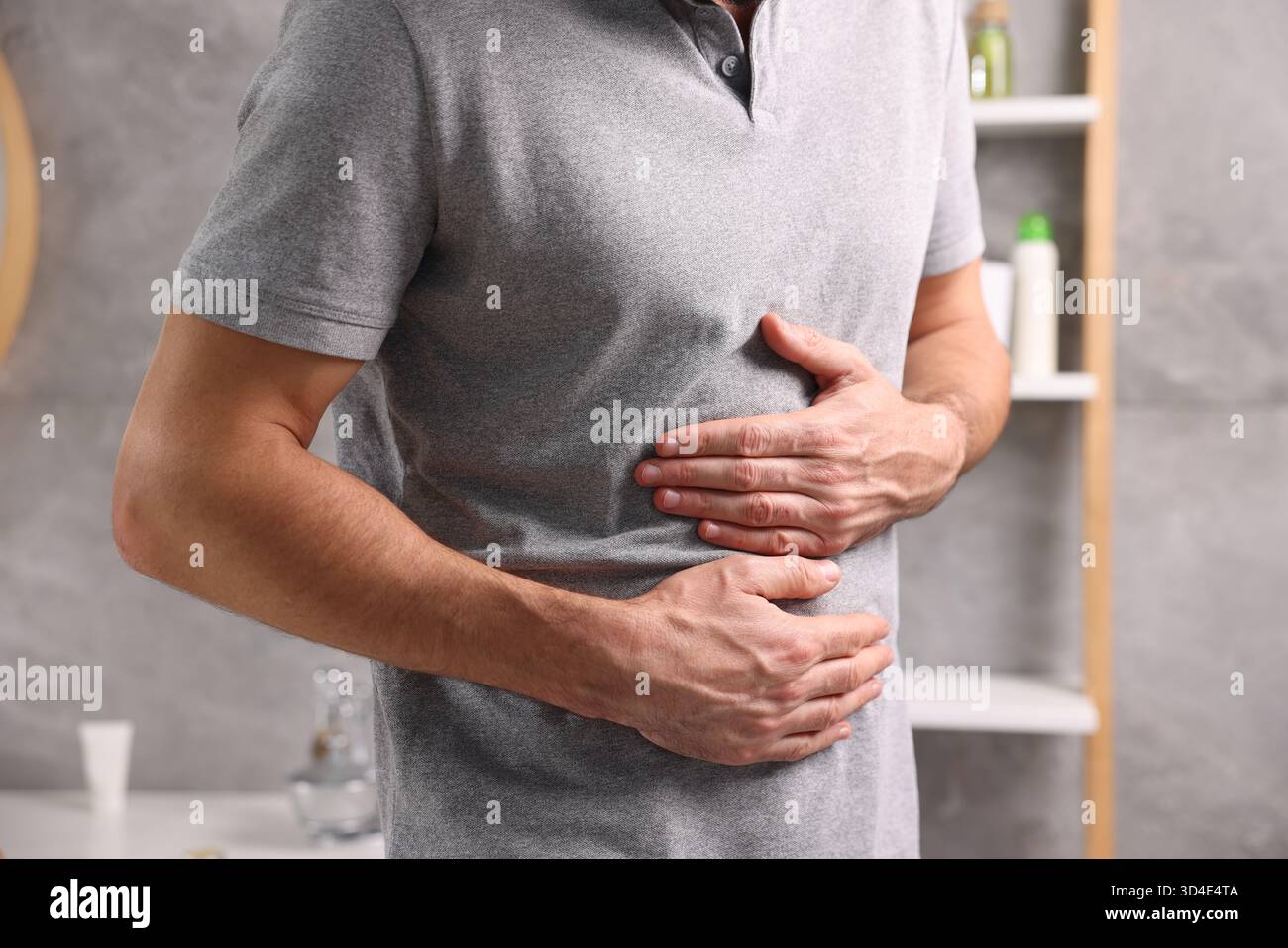 Man suffering from stomach ache and nausea in bathroom, closeup Stock ...