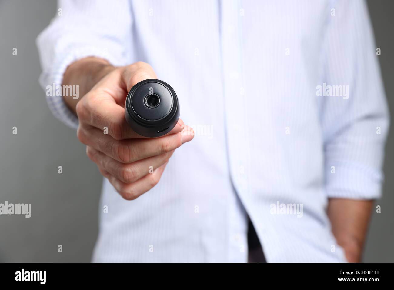 Man with hidden spy camera on grey background, closeup Stock Photo - Alamy