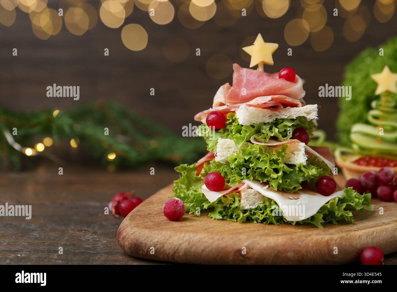 Christmas tree shaped snack made with lettuce, ham, croutons and ...