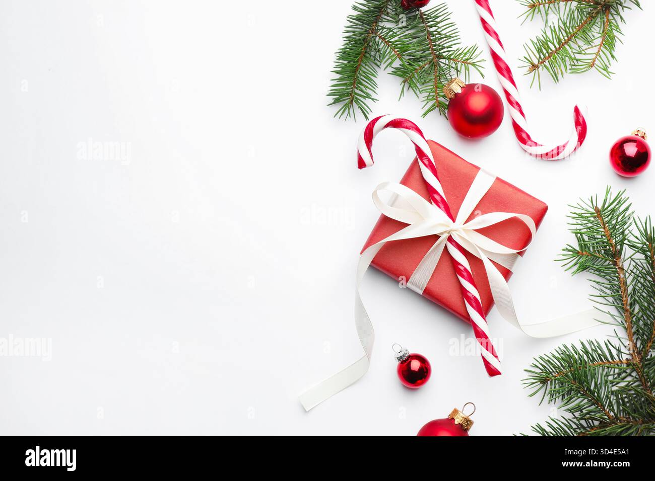 Fir tree branches, gift box and Christmas decor on white background ...