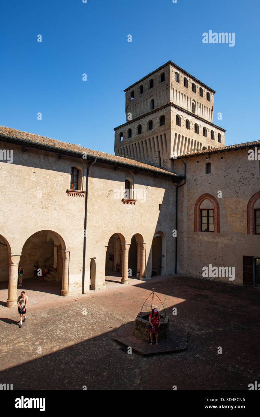 A serene view of an old Italian castle's inner courtyard featuring a ...