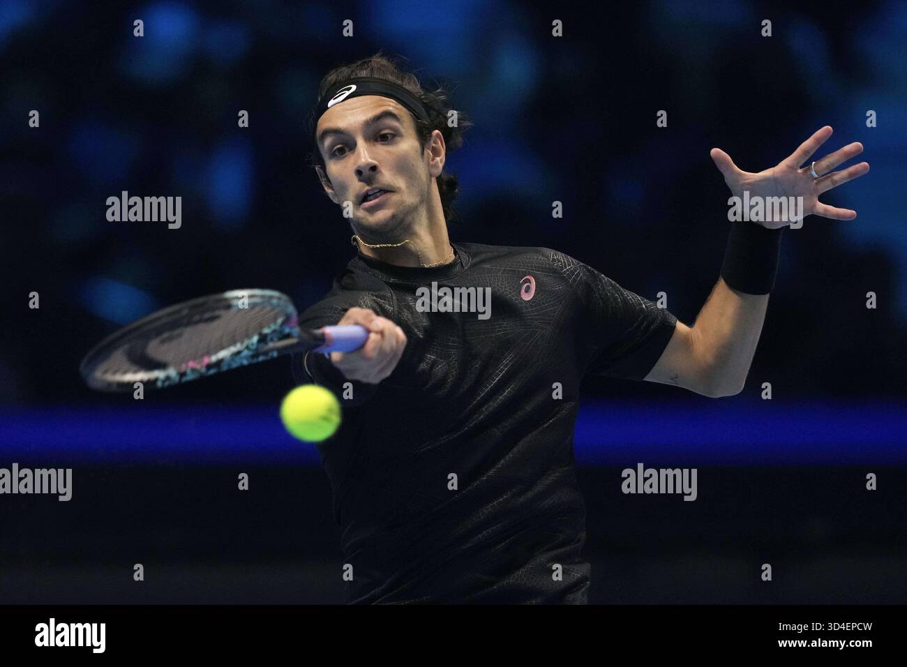 Italy's Lorenzo Musetti returns the ball to United States' Taylor Fritz ...