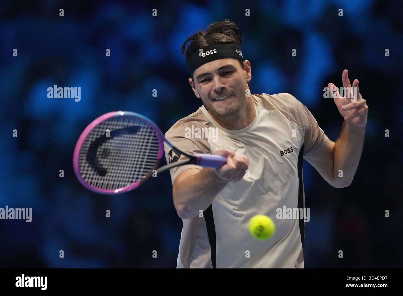 United States' Taylor Fritz returns the ball to Italy's Lorenzo Musetti ...