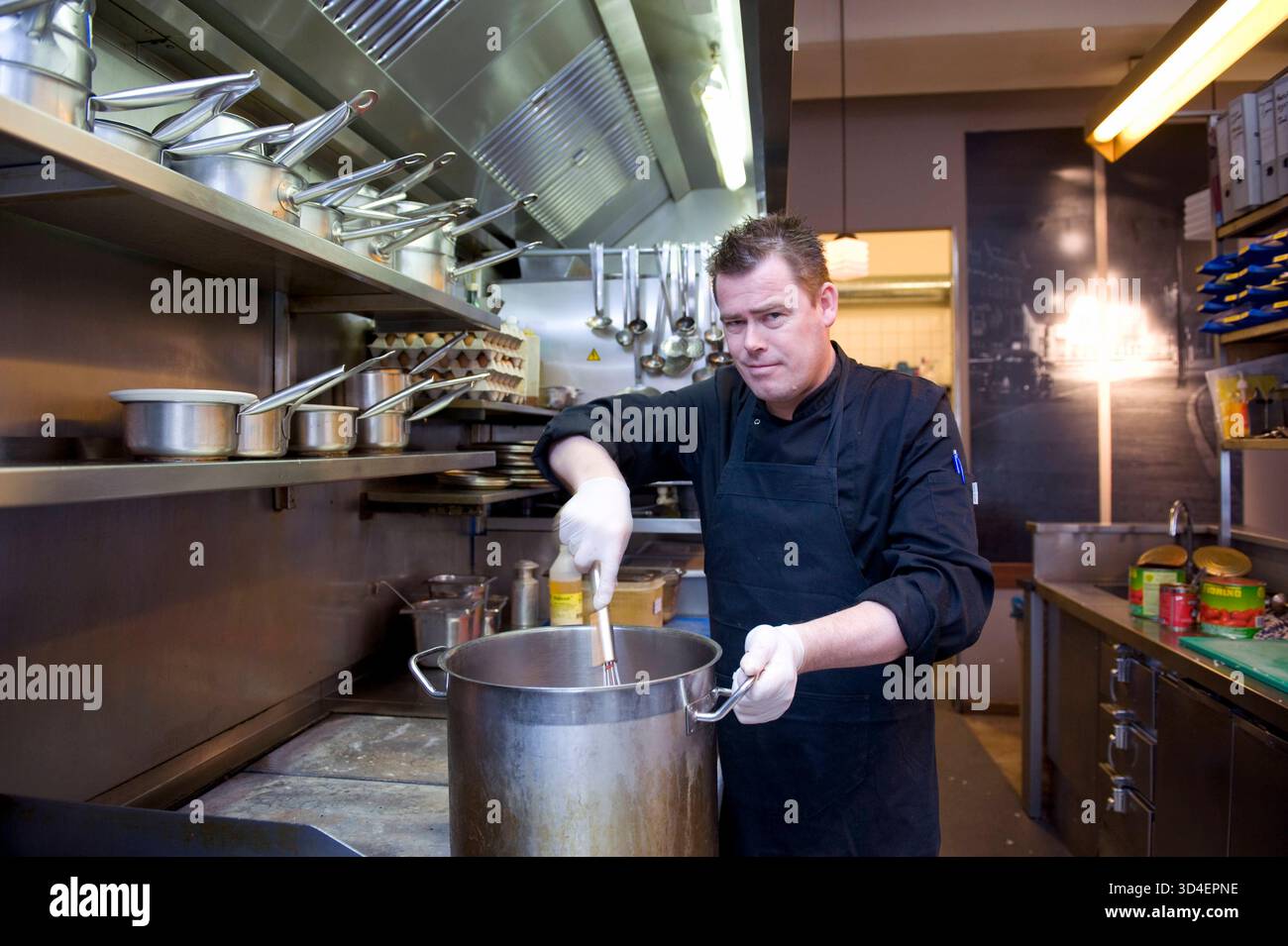 Chef de Cuisine. Male Chef de Cuisine, working insiude the Kitchen of ...