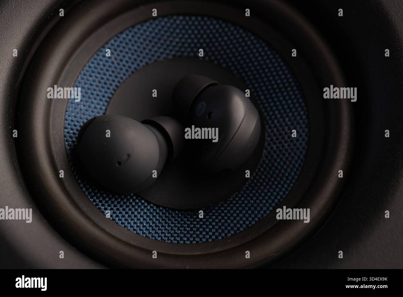 Close Up Wireless Earbuds Resting Inside Speaker Woofer Stock Photo - Alamy