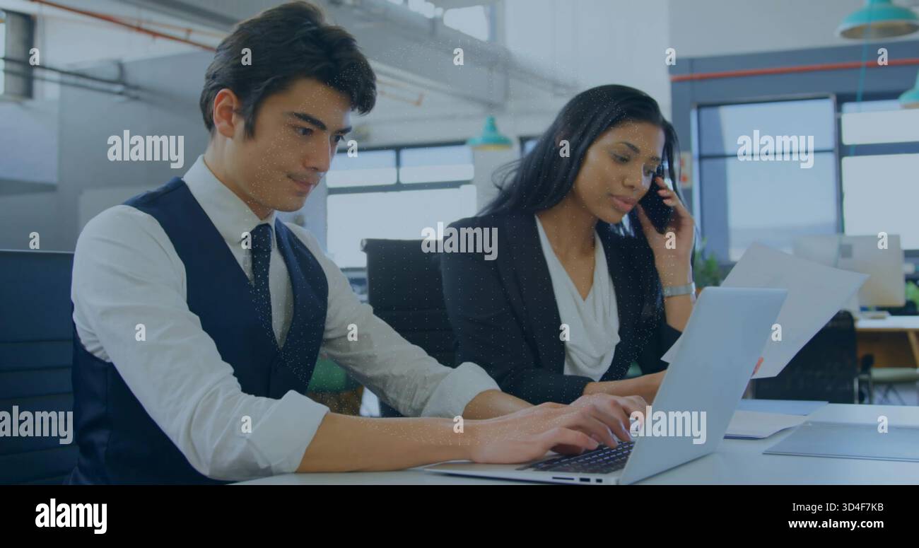 Typing man and speaking woman in business attire, reviewing papers at ...
