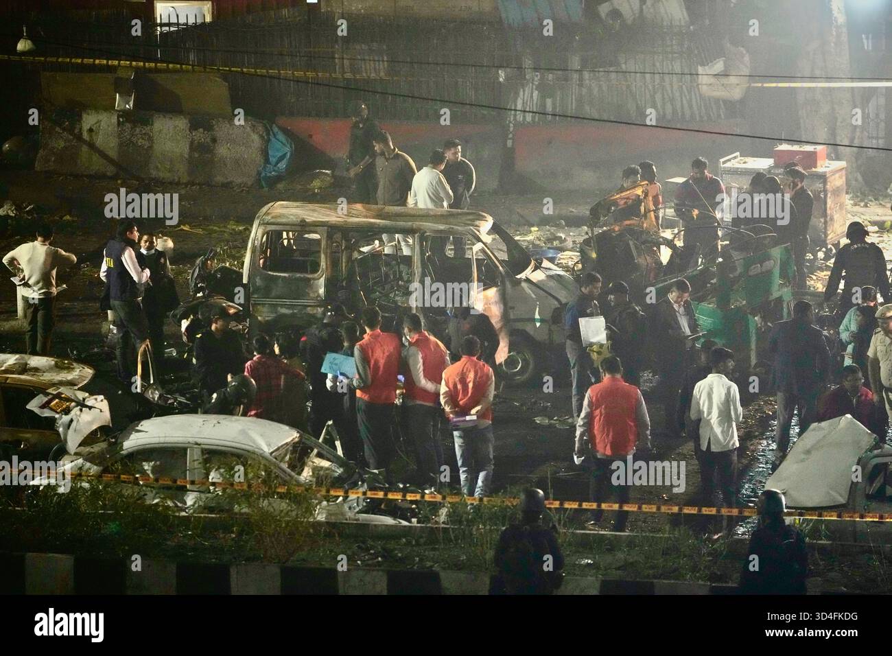 Security officials inspect the scene of a car explosion near the ...