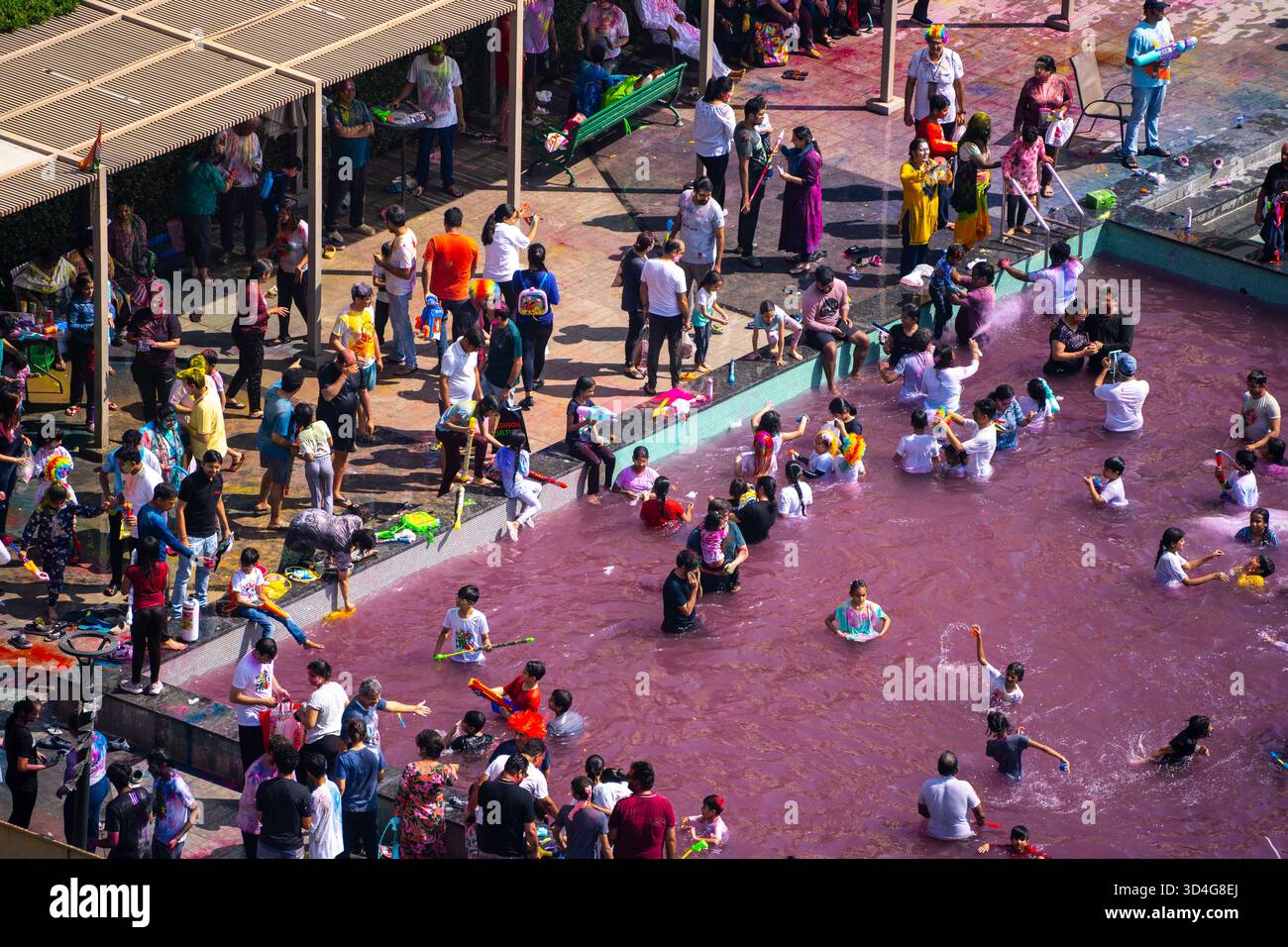 Zoomed shot of crowd of people playing hindu holi festival of colors in ...