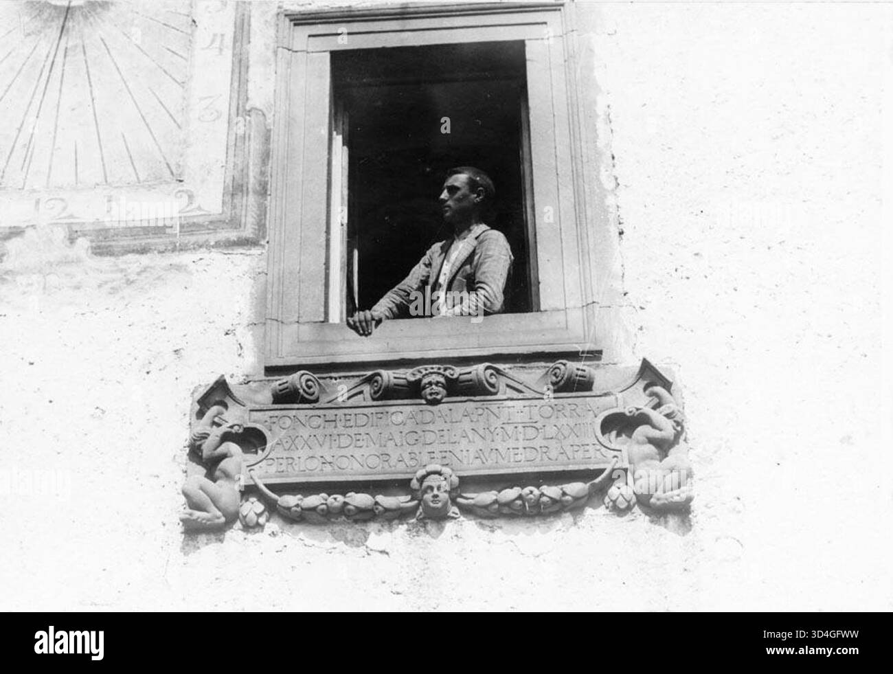 Photograph of the window of Can Draper with a man beneath an ...