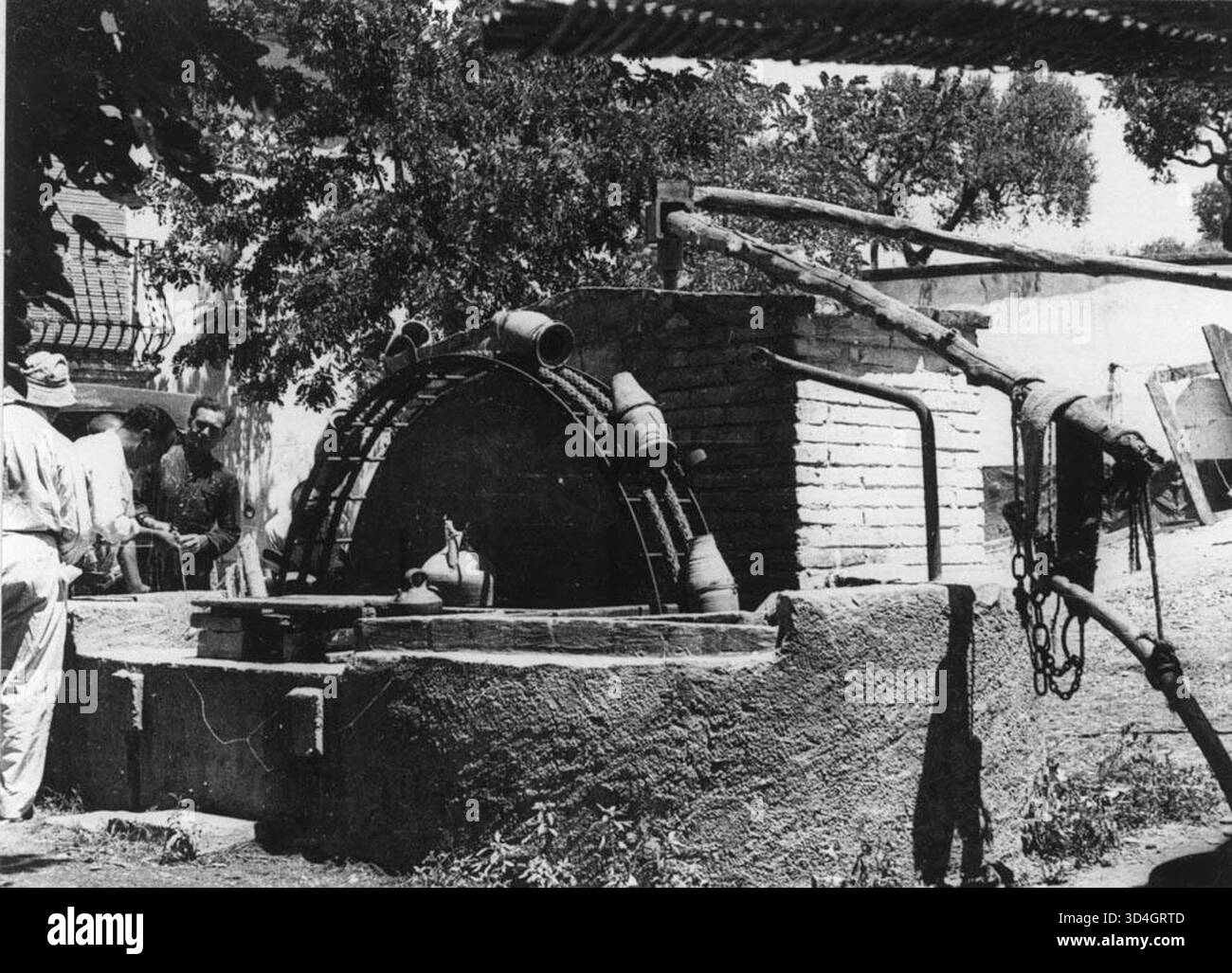 Men gathering water from a well at Mora la Nova, photographed by Antoni ...