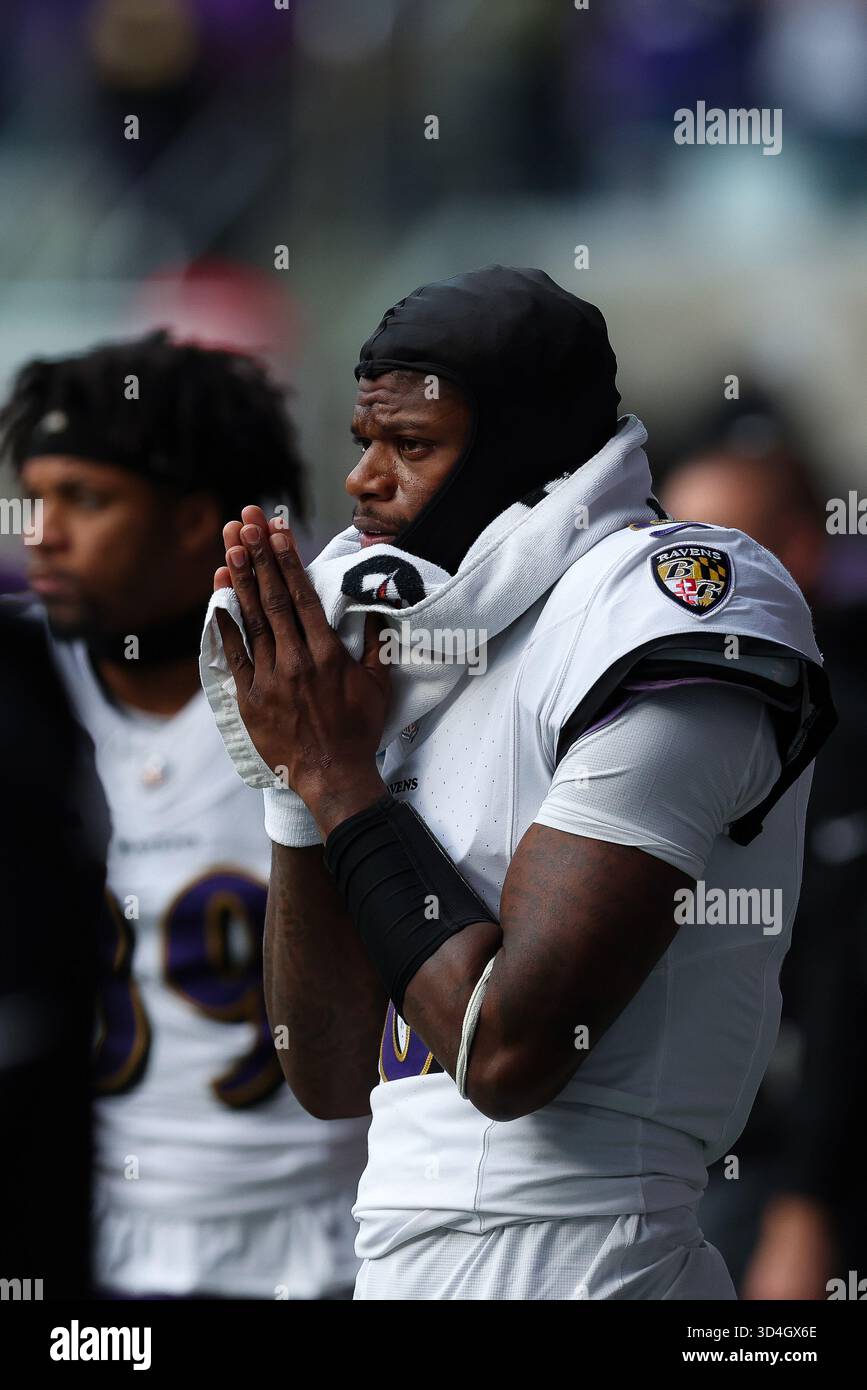 Baltimore Ravens quarterback Lamar Jackson stands on the sideline ...