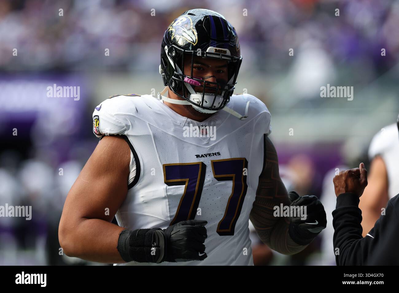 Baltimore Ravens guard Daniel Faalele (77) walks on the field before an ...