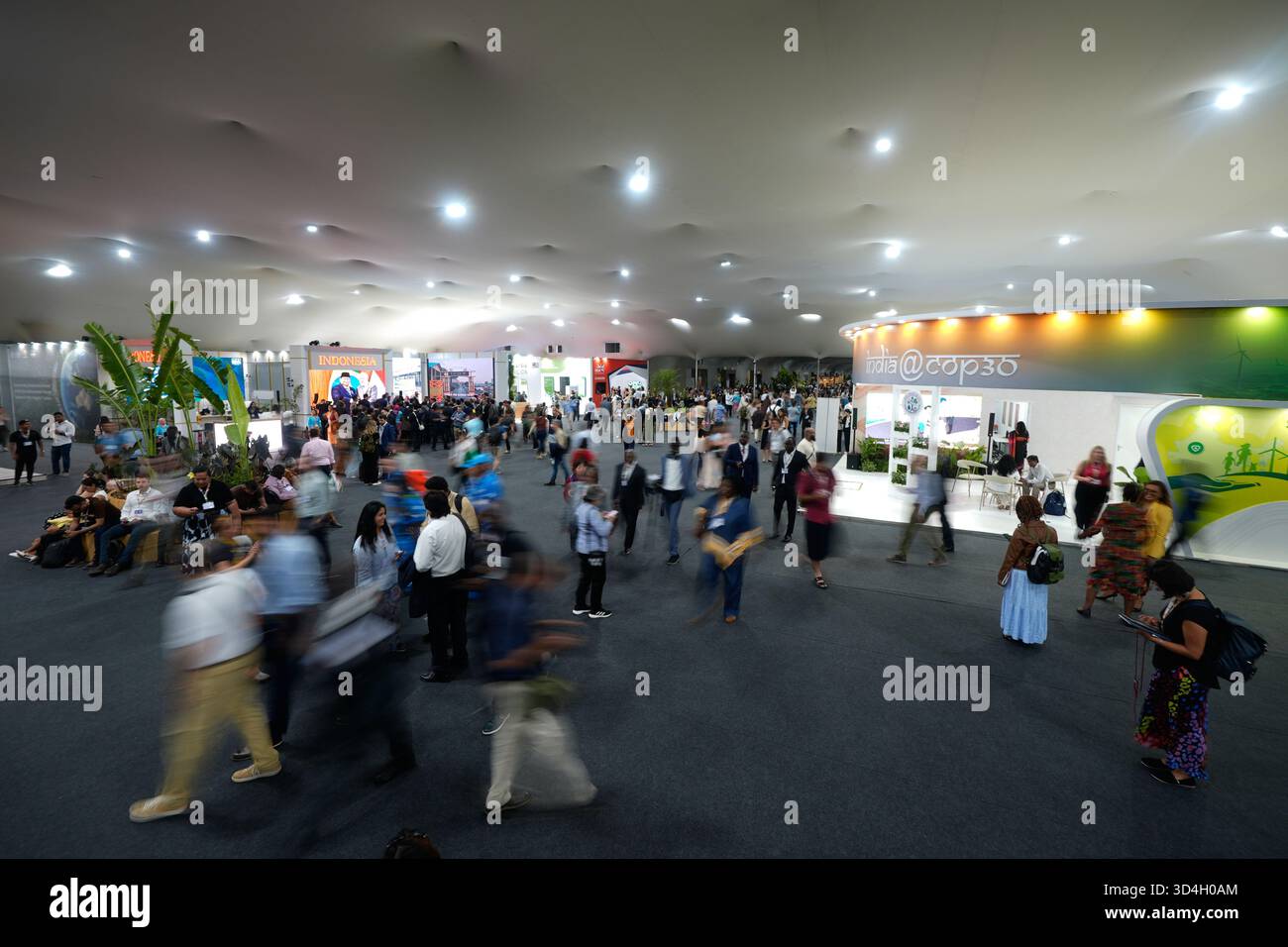People walk through pavilions at the COP30 U.N. Climate Summit, Monday ...