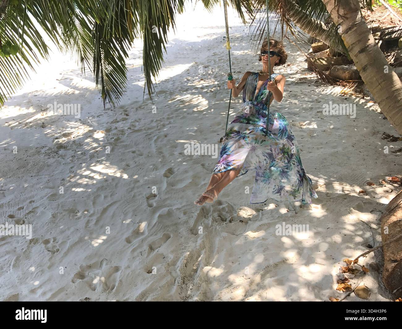Beach swinging on a rope palm tree hi-res stock photography and images ...