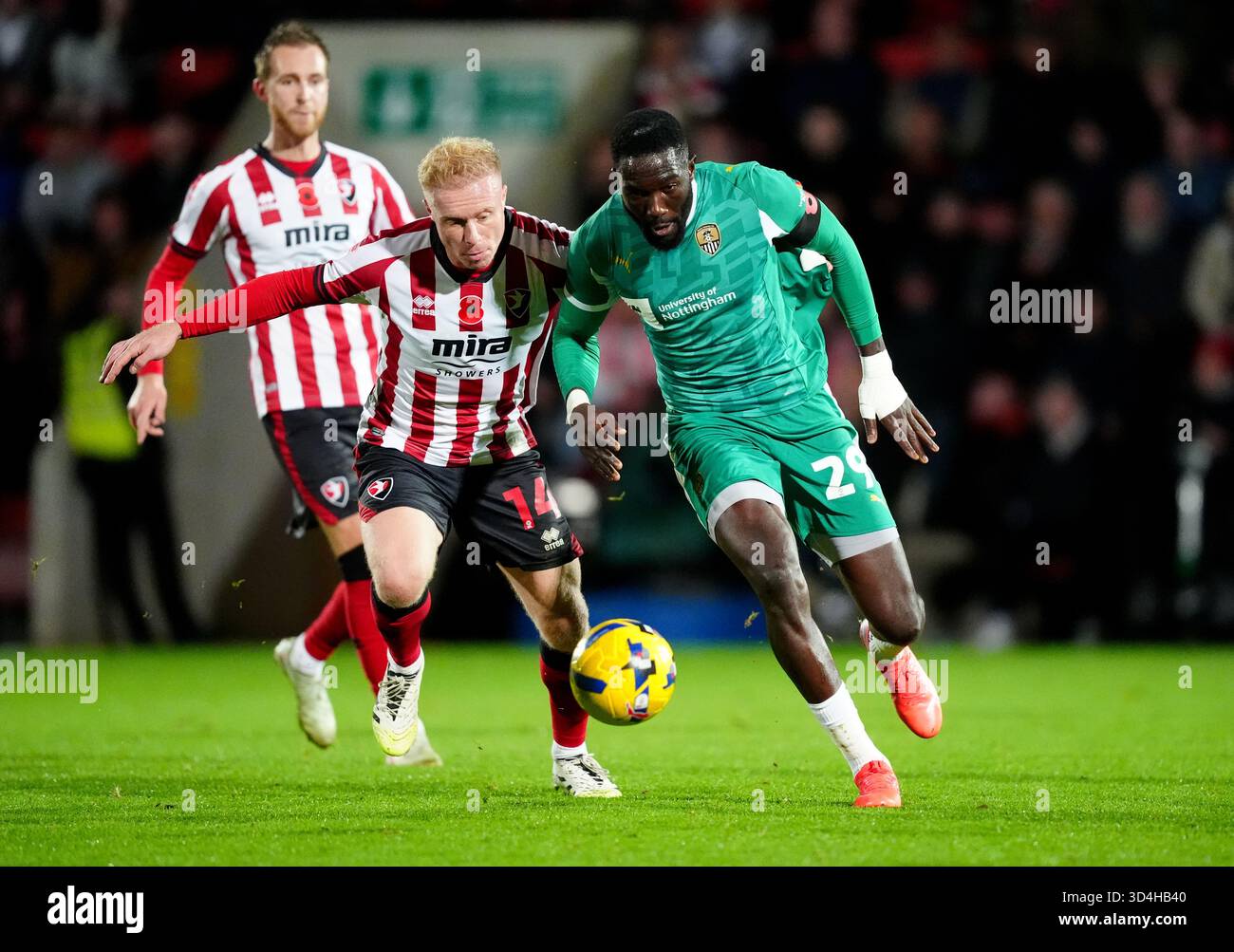 Notts County's Alassana Jatta (right) and Cheltenham Town's Ryan Broom ...