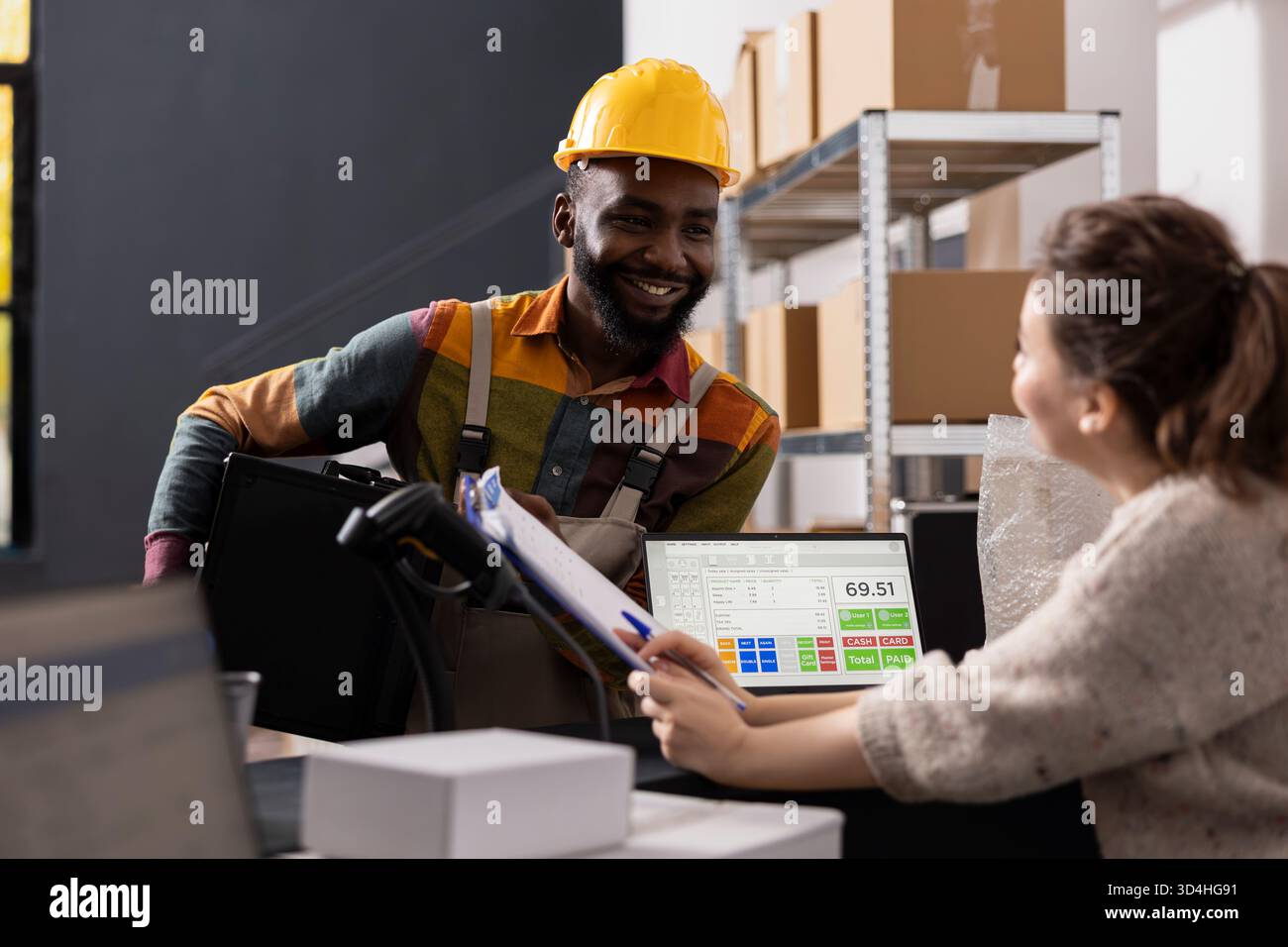 Diverse employees checking inventory list and order processing systems ...