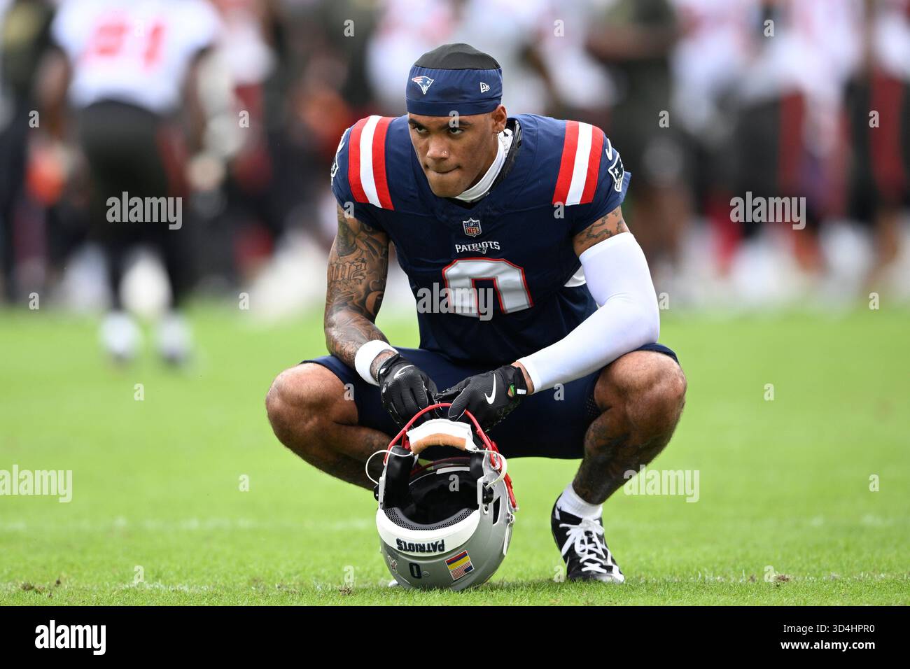 New England Patriots cornerback Christian Gonzalez (0) warms up before ...