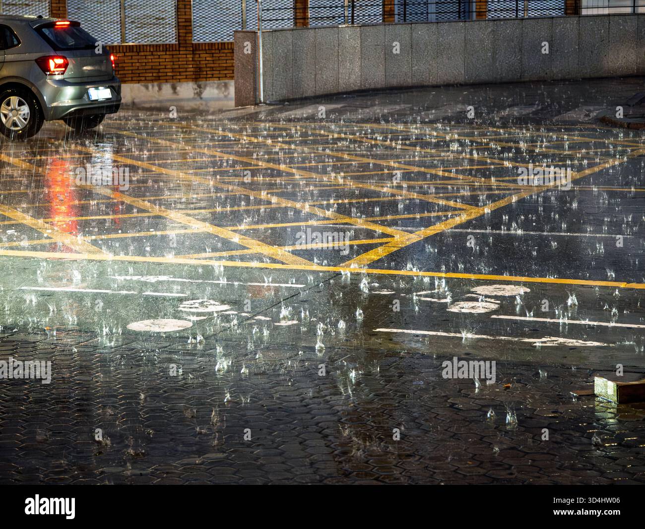 **Heavy rain over the bike lane and roadway in Seville, with puddles ...