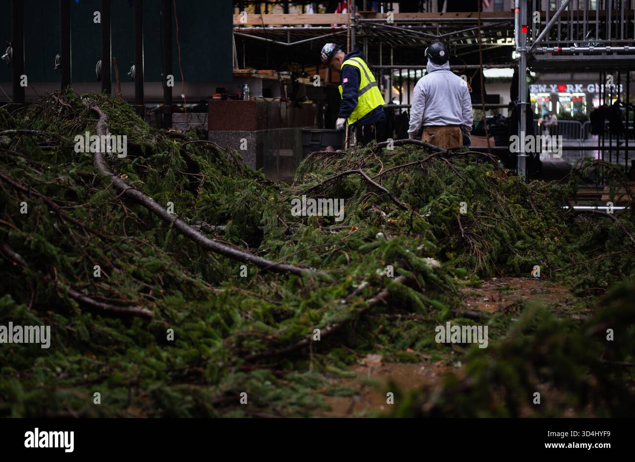 New York, New York, USA. 10th Nov, 2025. Workers stands below the ...