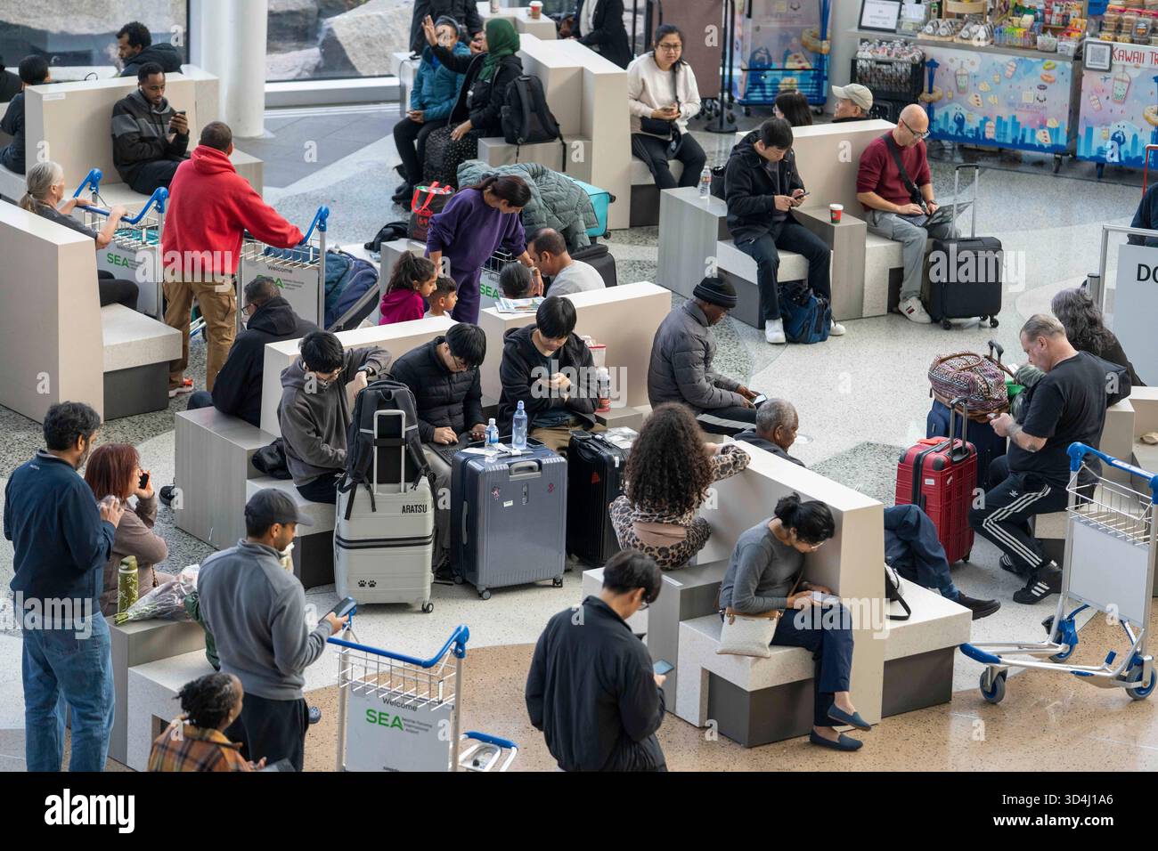 November 10, 2025, Seatac, Washington, USA: Travelers wait outside a ...