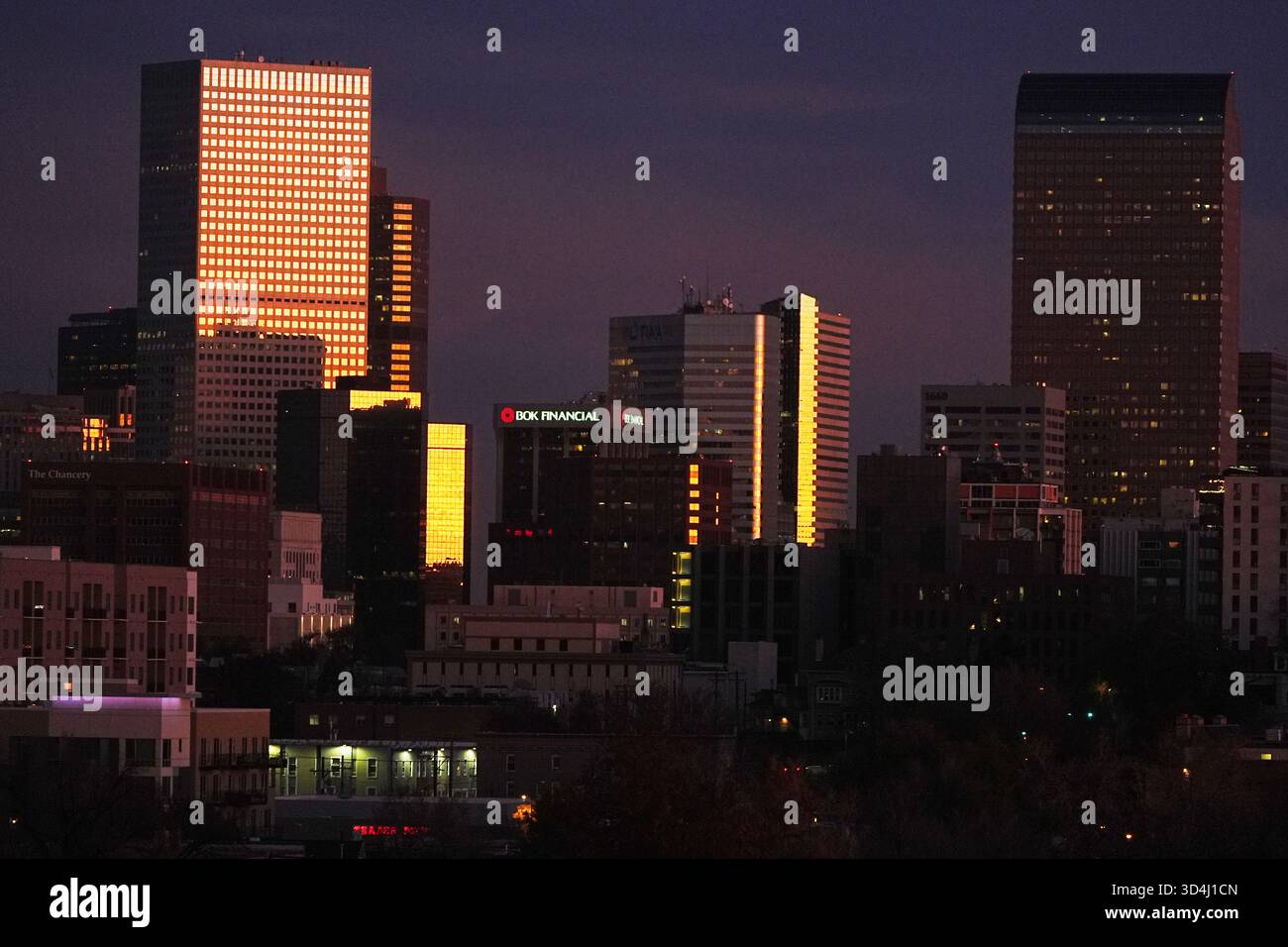 The rising sun illuminates the skyline Monday, Nov. 10, 2025, in Denver ...