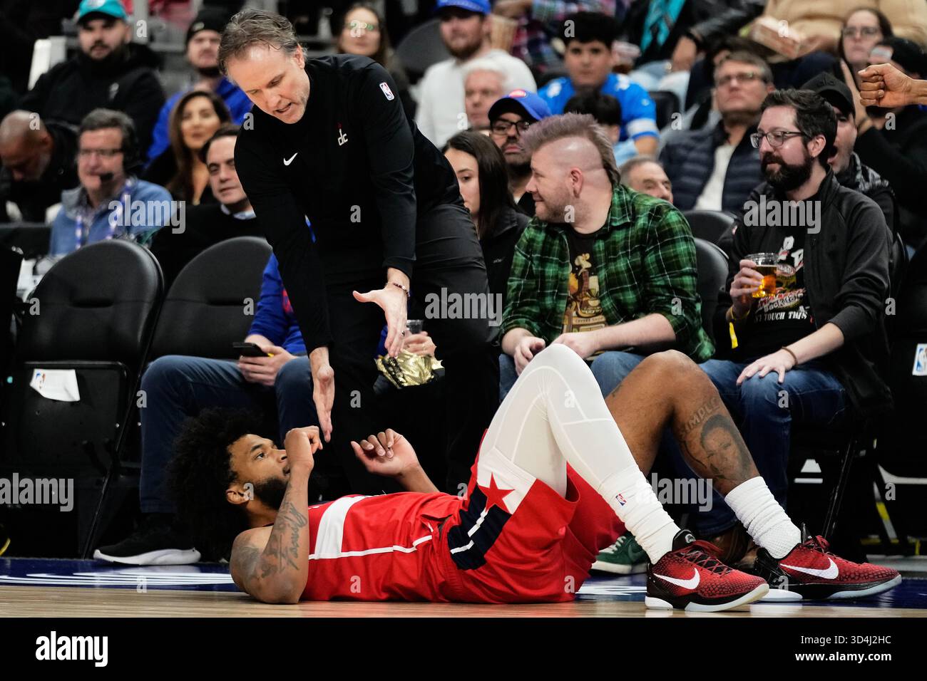 Washington Wizards head coach Brian Keefe, top, helps center Marvin ...