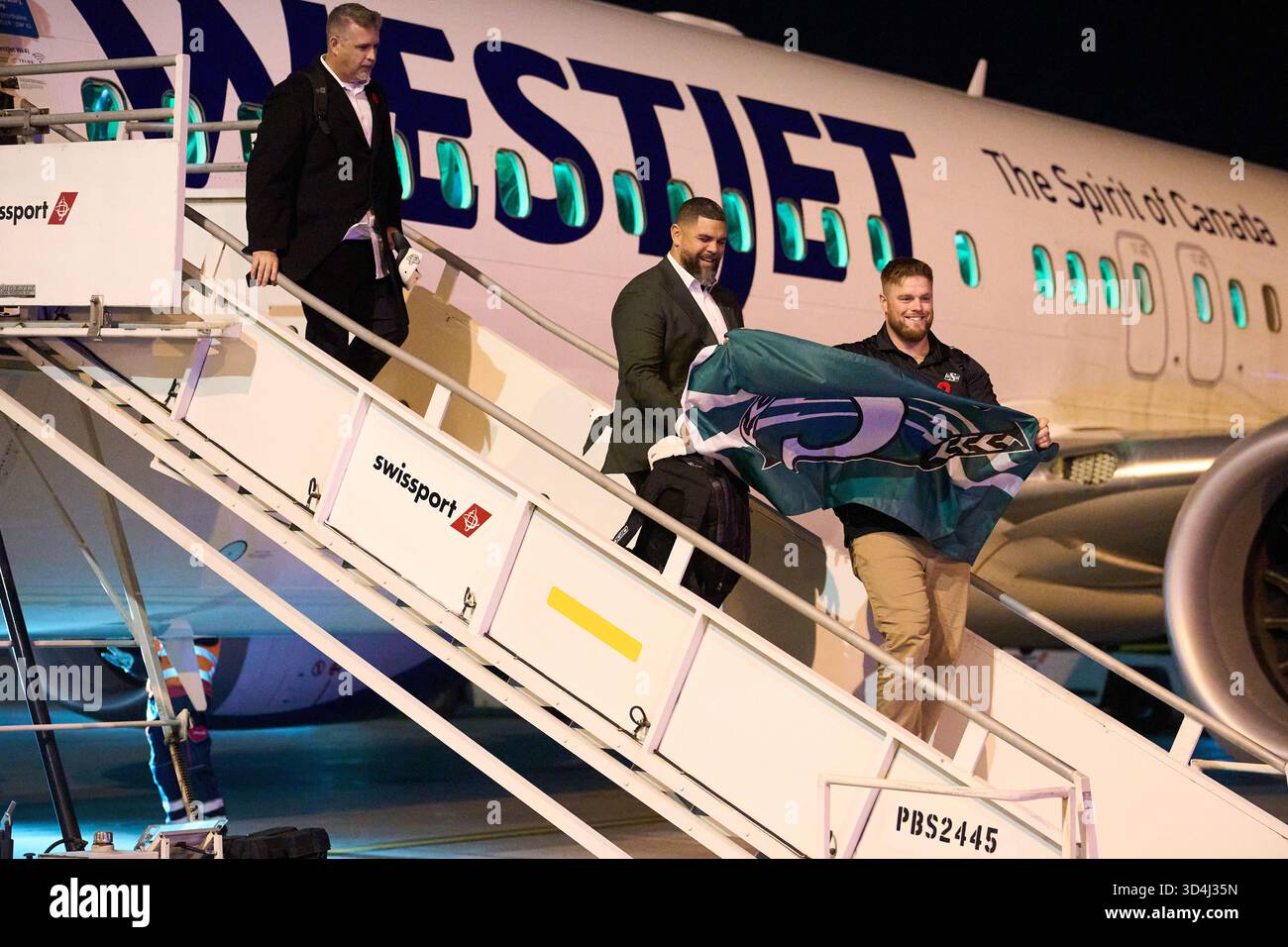 Saskatchewan Roughriders' Logan Ferland and head coach Corey Mace wave ...