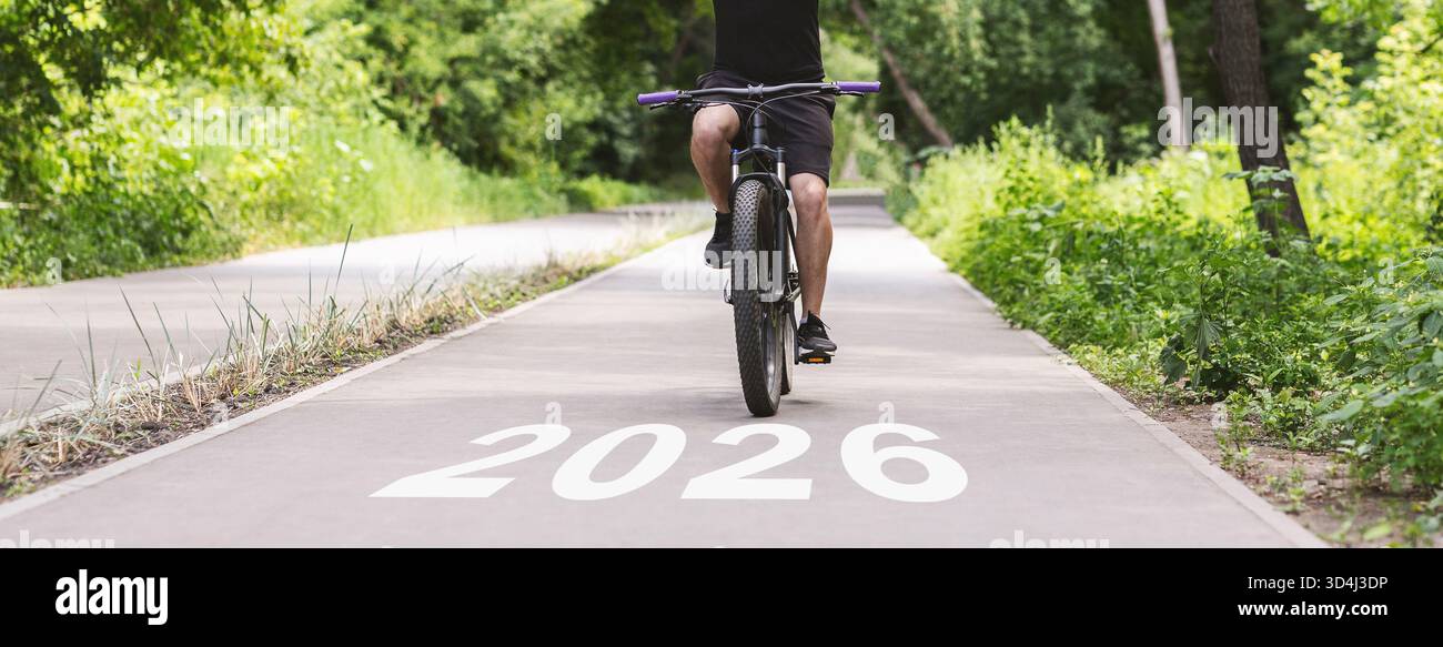 Cyclist Enjoying a Ride on a Sunny Day Along a Path Marked by the Year ...