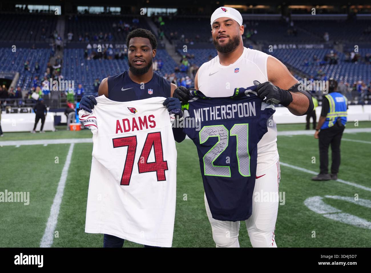 Seattle Seahawks cornerback Devon Witherspoon, left, trades jerseys ...