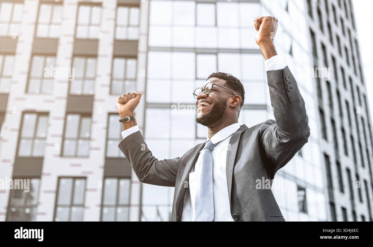 Successful Businessman Celebrates Achievement Outside Modern Office ...