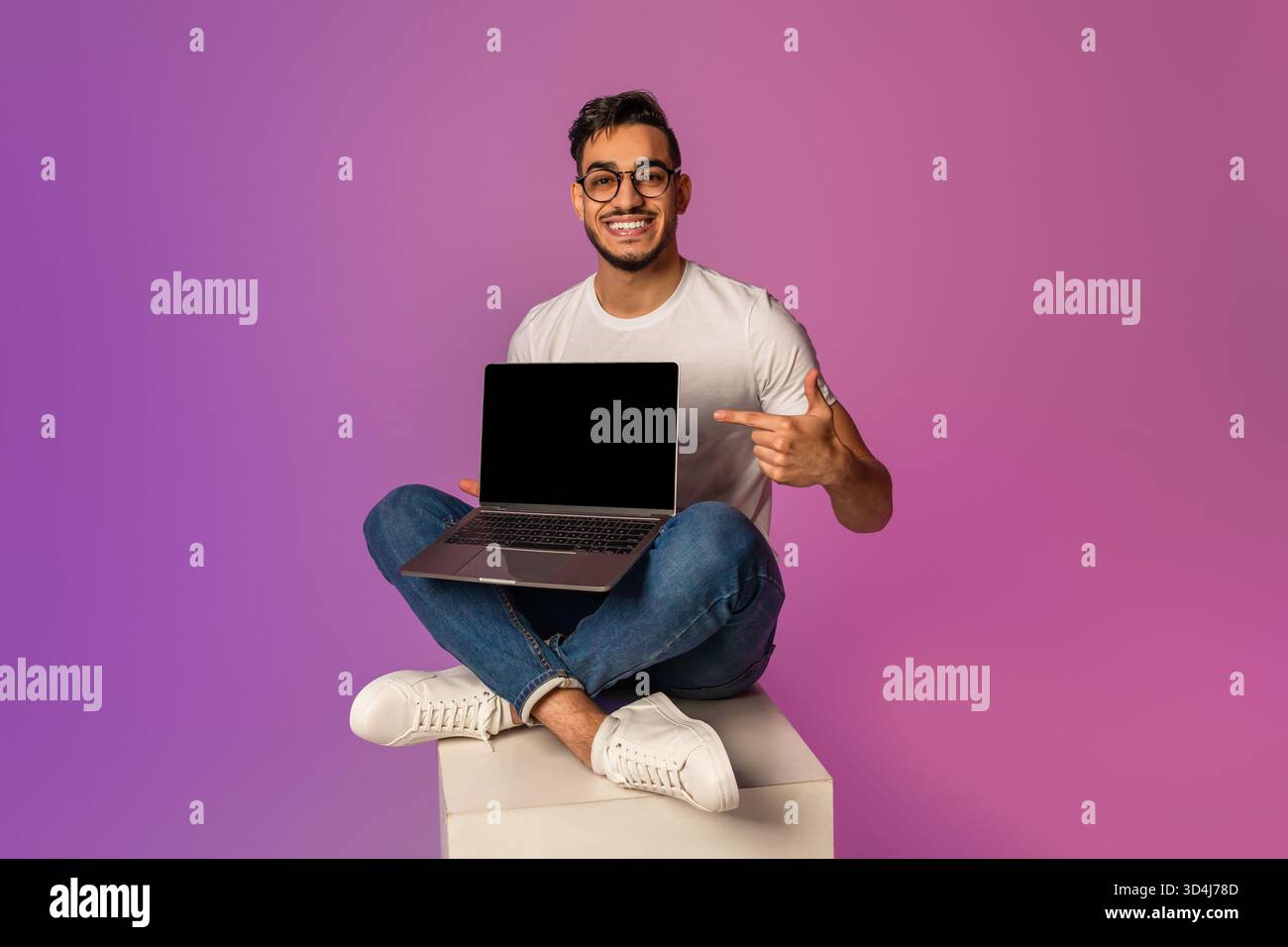 Happy Arab Man Shows Blank Laptop Screen for Mockup in Neon Light ...