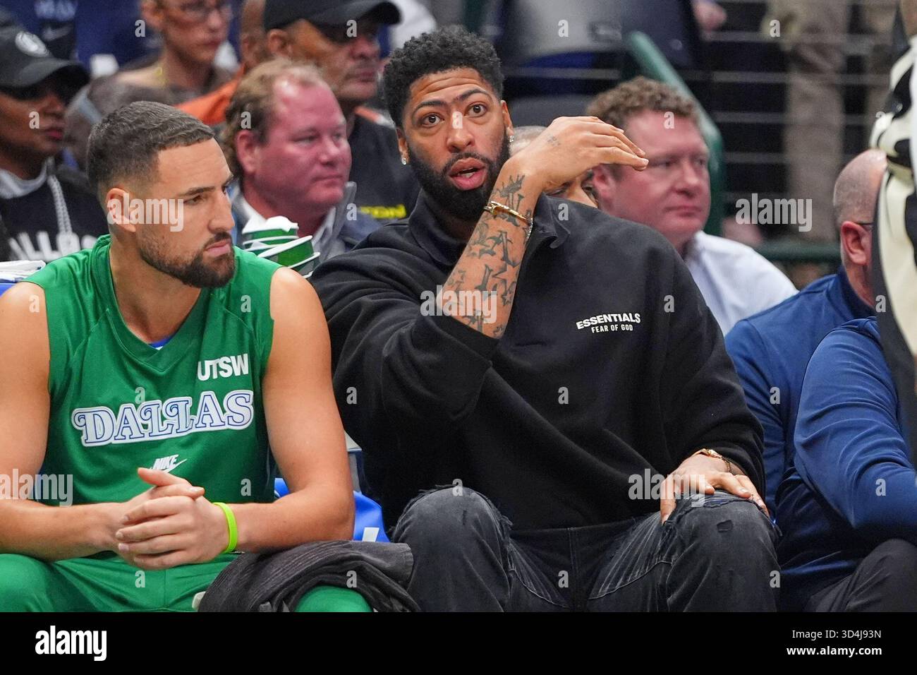Dallas Mavericks forward Anthony Davis, right, sits on the bench with ...