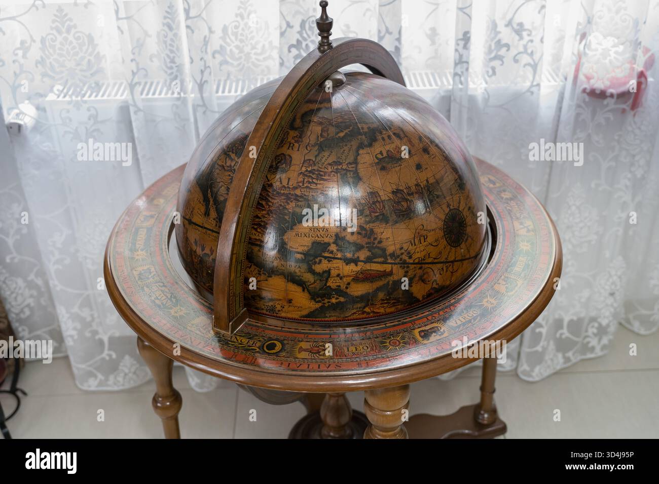 A 20th century globe drinks cabinet with veneered hinged topped ...