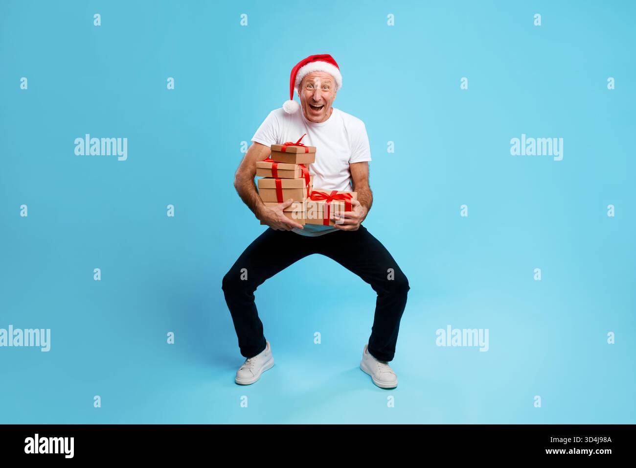 Joyful Mature Man in Santa Hat Holds Christmas Presents in Festive ...