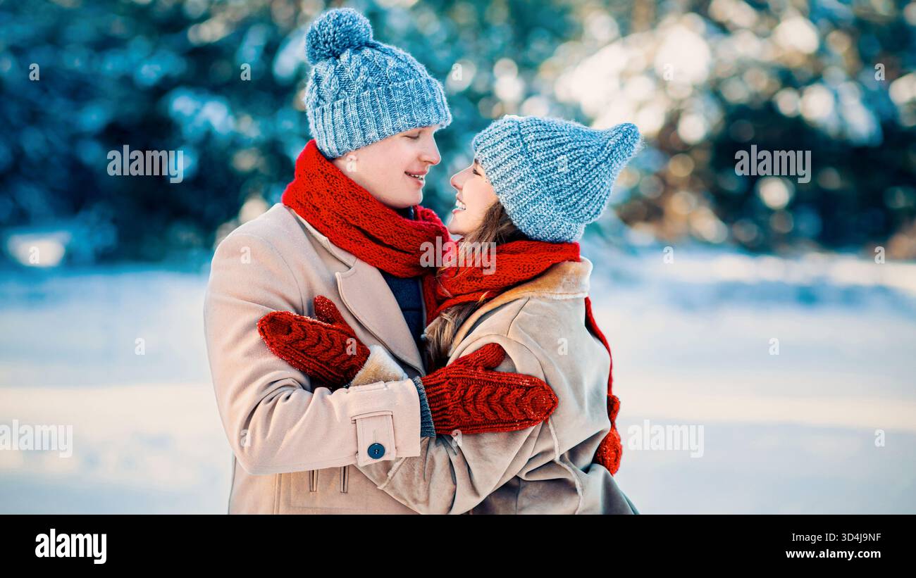 Couple Enjoys Winter Day in the Snow Wearing Warm Hats and Scarves ...