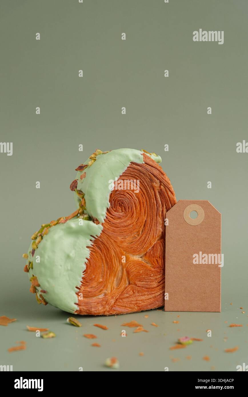 Empty paper note template mock up. Heart shaped pistachio croissant on ...