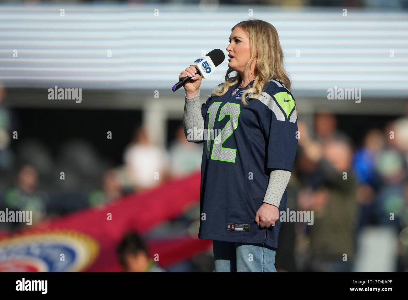Tricia Scheer of the Washington Army National Guard sings the national ...