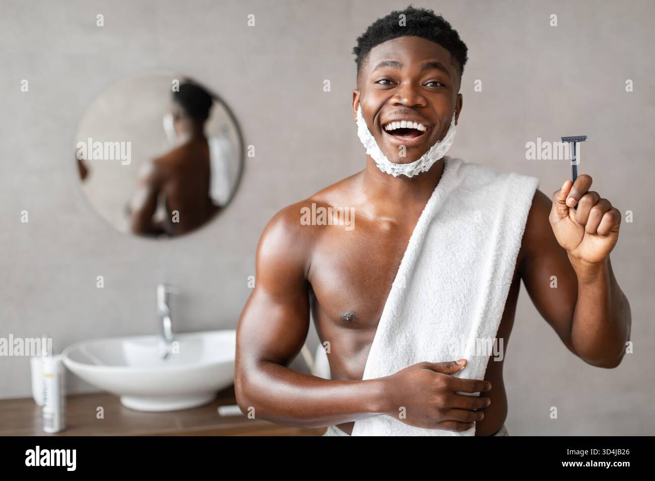 Excited Black Man Enjoys Shaving Routine in Modern Bathroom at Home ...