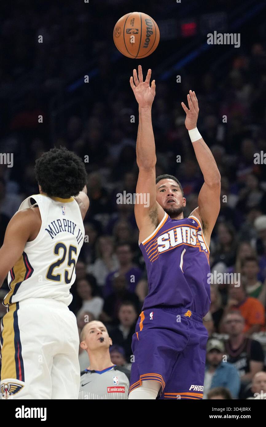 Phoenix Suns guard Devin Booker, right, shoots over New Orleans ...