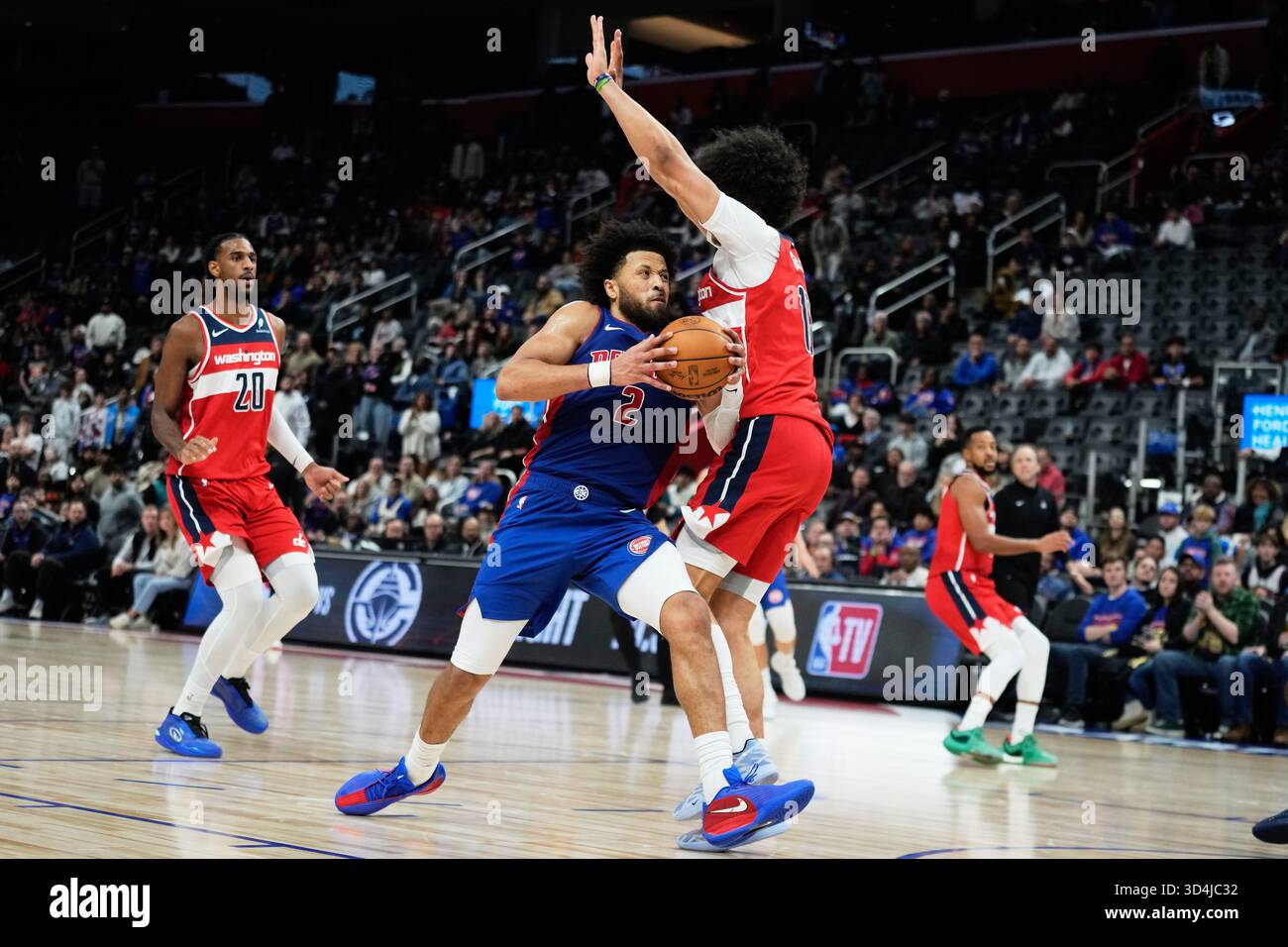 Detroit Pistons guard Cade Cunningham, left, drives against Washington ...