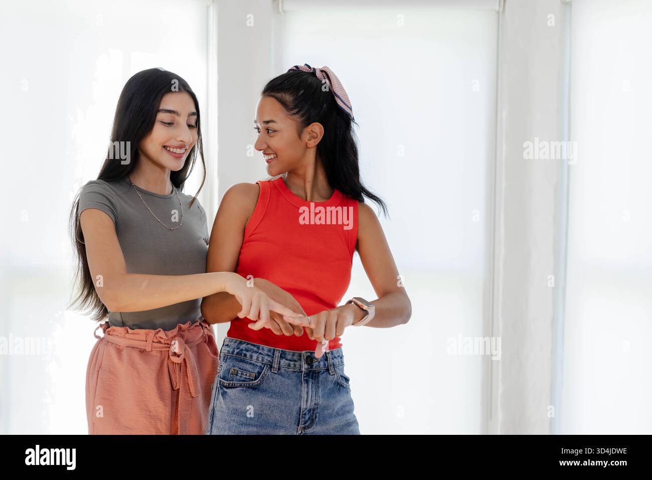 Practicing dance Diverse female friends touching fingertips in studio ...