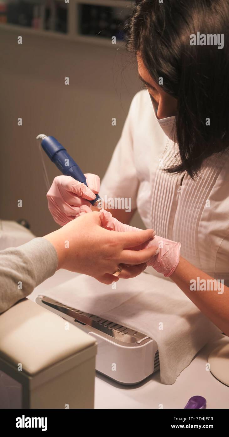 Manicure technique. Nail treatment. Female beautician hand in gloves ...