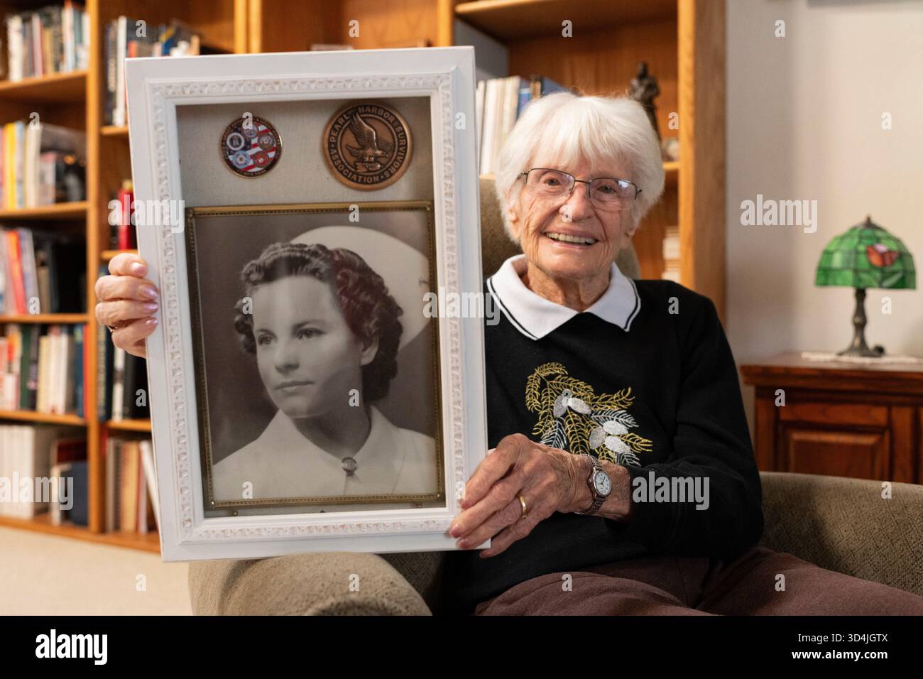 Alice Darrow shows a photo of herself from when she was a nurse during ...